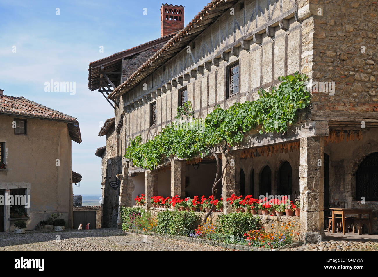 Hostellerie de Perouges with red geranium flowers Place du Tilleul ...