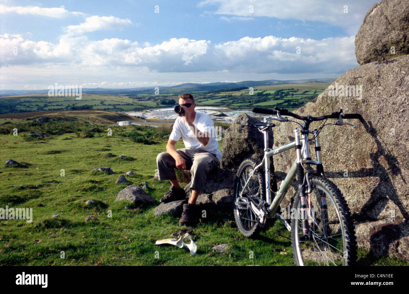 cyclist stops for a rest and a drink near Cadover Bridge, Dartmoor ...