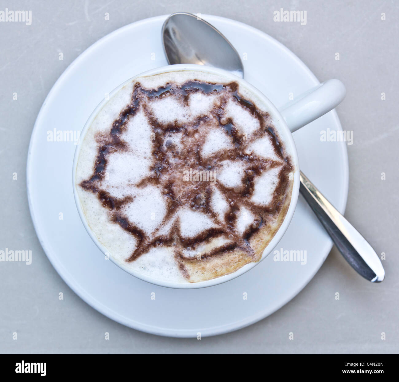 Cappucino as presented by an Italian café - cobweb pattern of chocolate ...