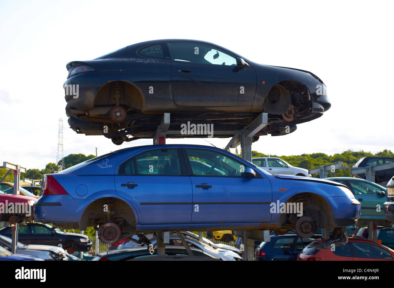 Cars stacked up in a scrapyard Stock Photo - Alamy