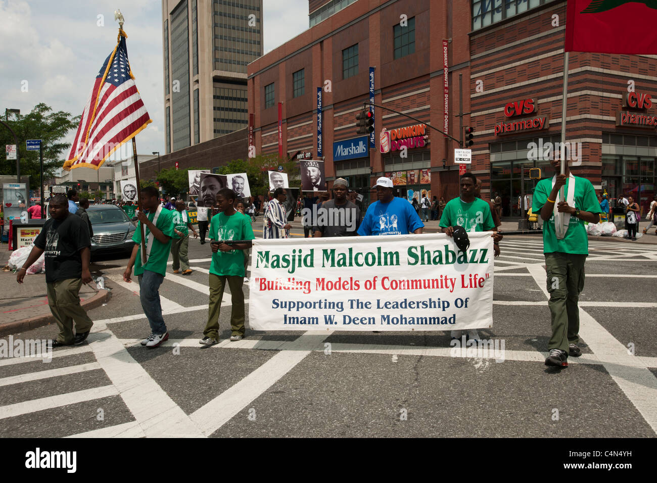 Participants march in the Juneteenth celebration parade through the ...