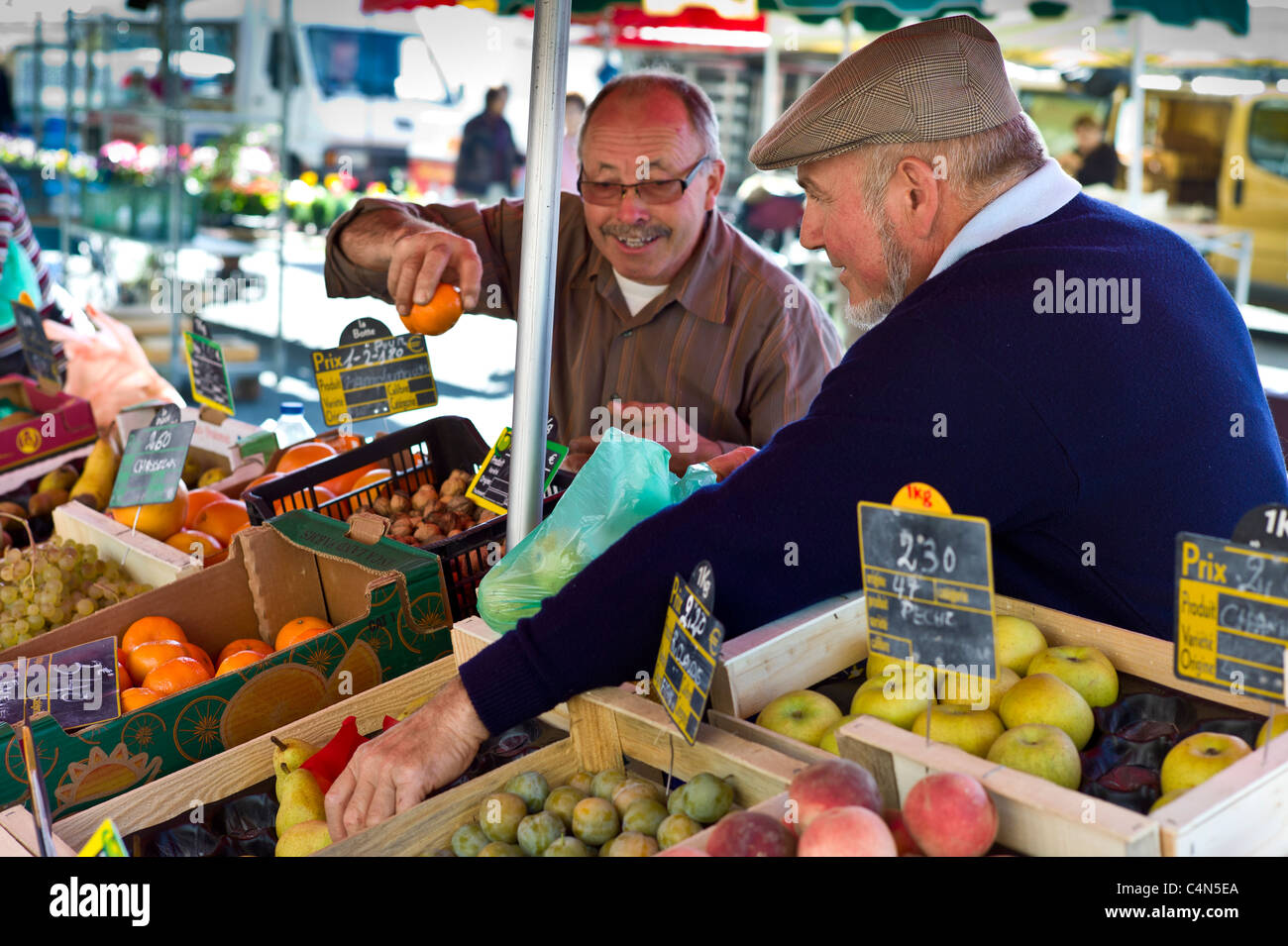 Frenchmen working on fruit staff at food market at Esplanade des Quais ...