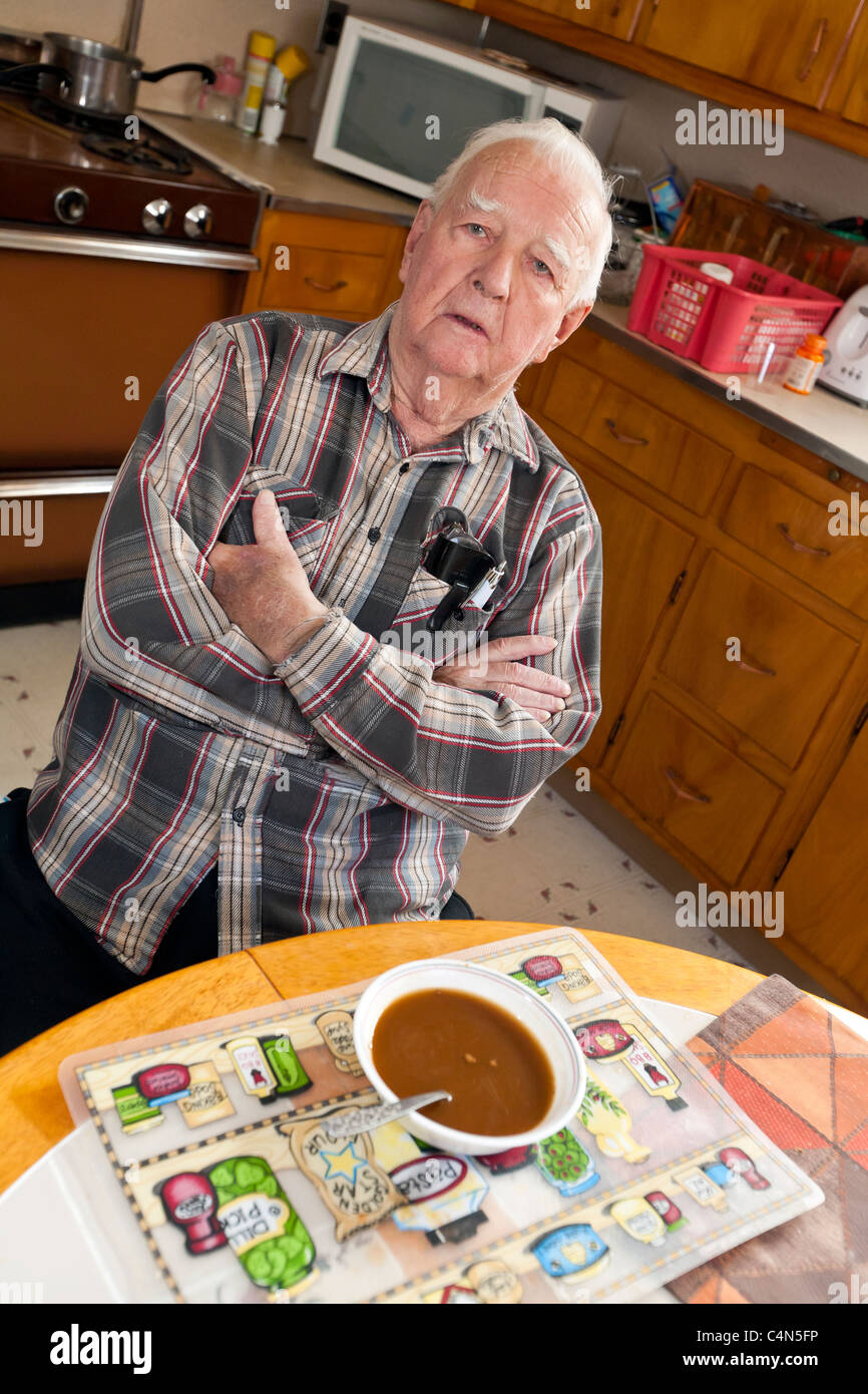 A retired elderly Senior Man in his home eating soup Stock Photo - Alamy
