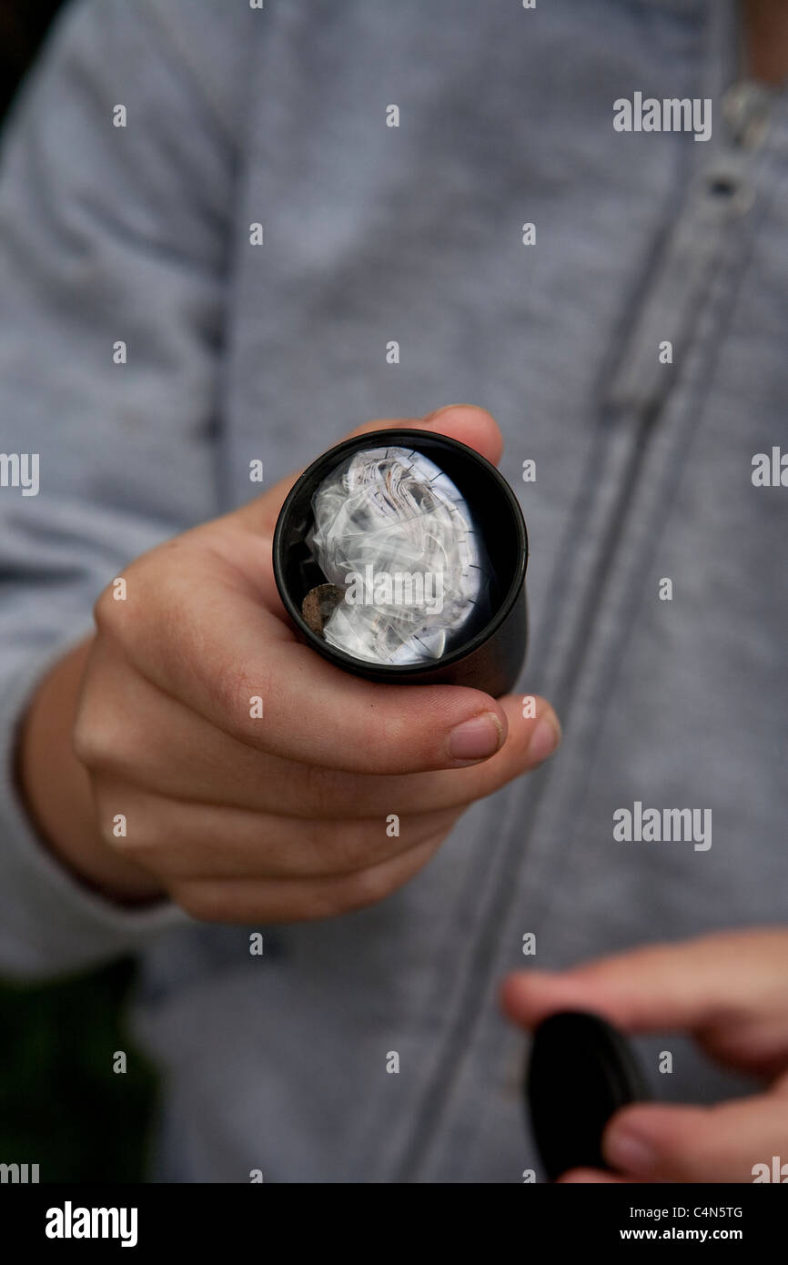 An open micro-cache held by a boy Stock Photo - Alamy