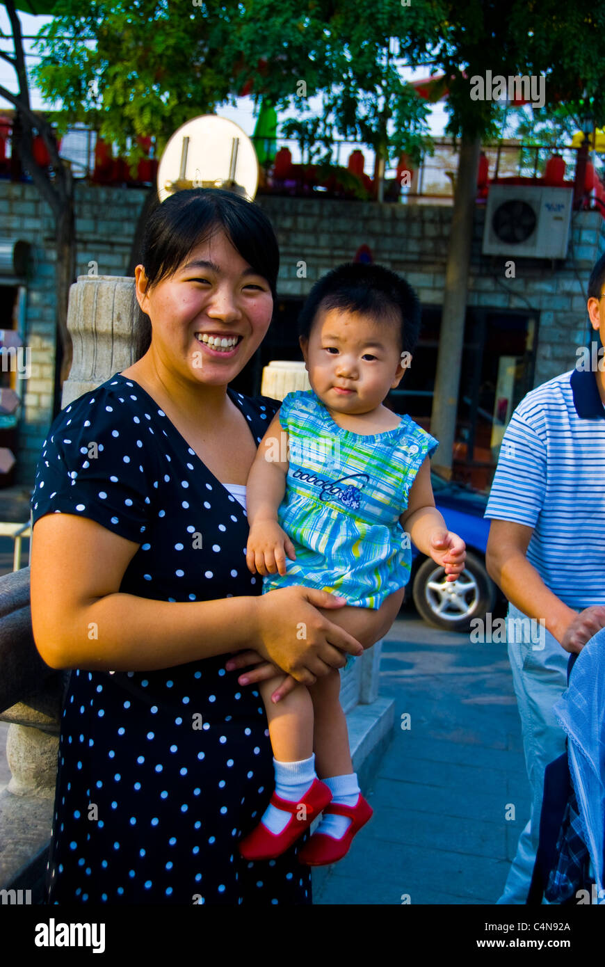 Beijing, China, Chinese Mother Posing with ENfant in Arms on Street ...