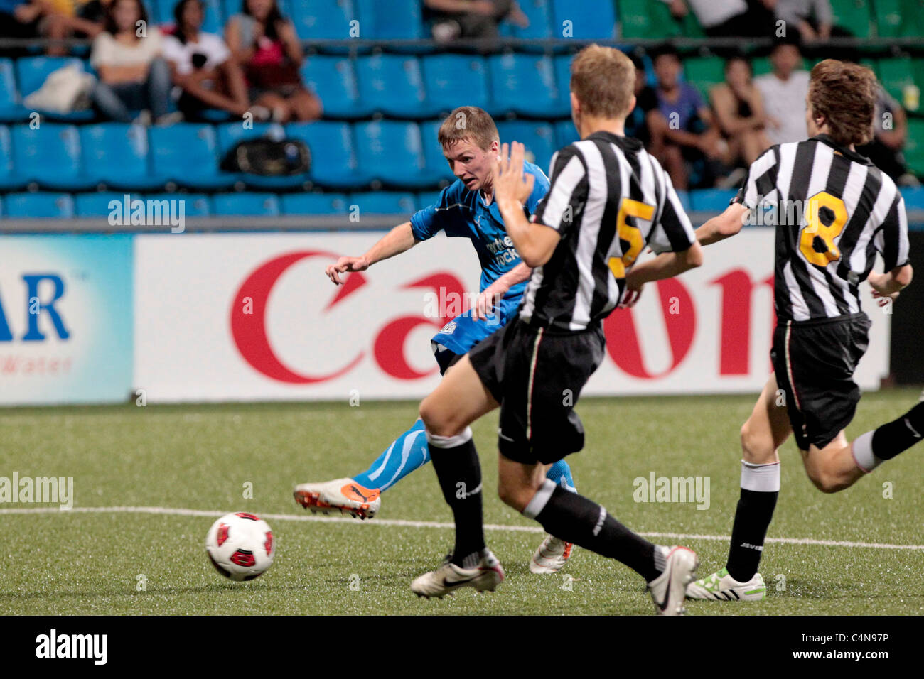 Andrew Hall of Newcastle United FC U15(blue) takes a shot at goal ...