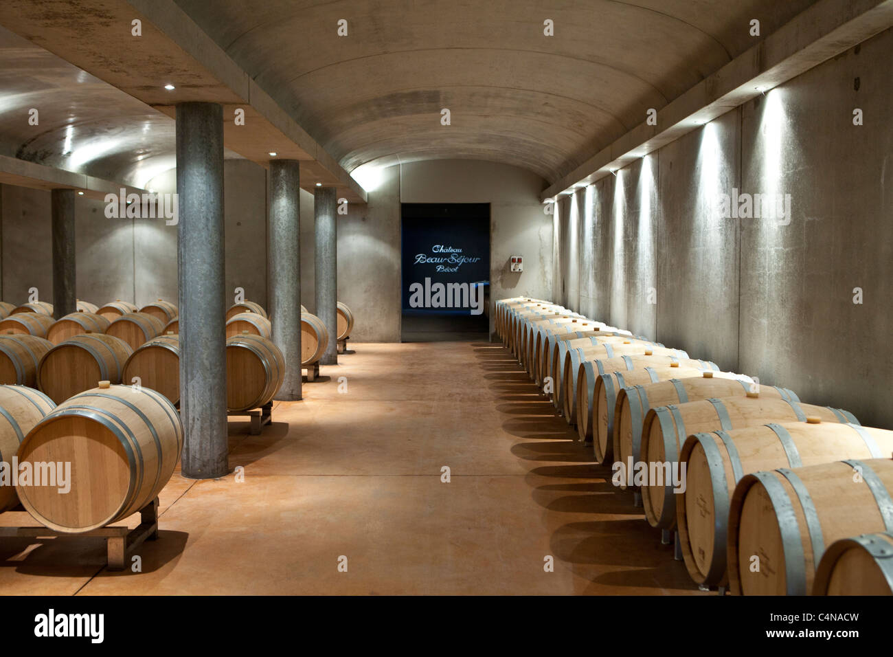 Oak wine barrels in cave at Chateau Beau-Sejour Becot at St Emilion in ...