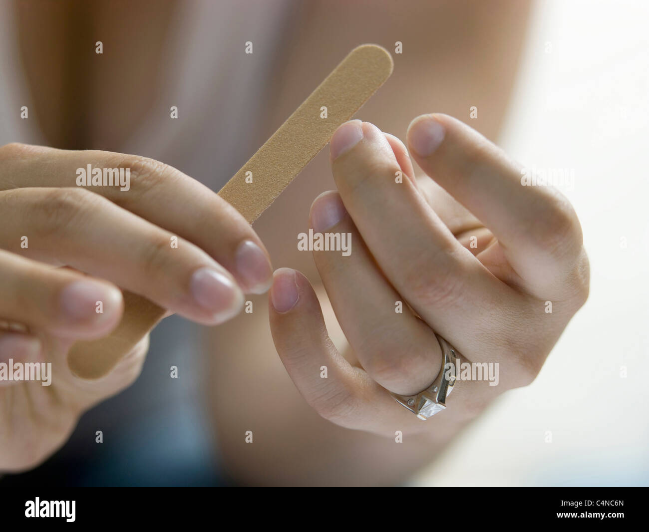 Close-up of woman filing her nails Stock Photo - Alamy