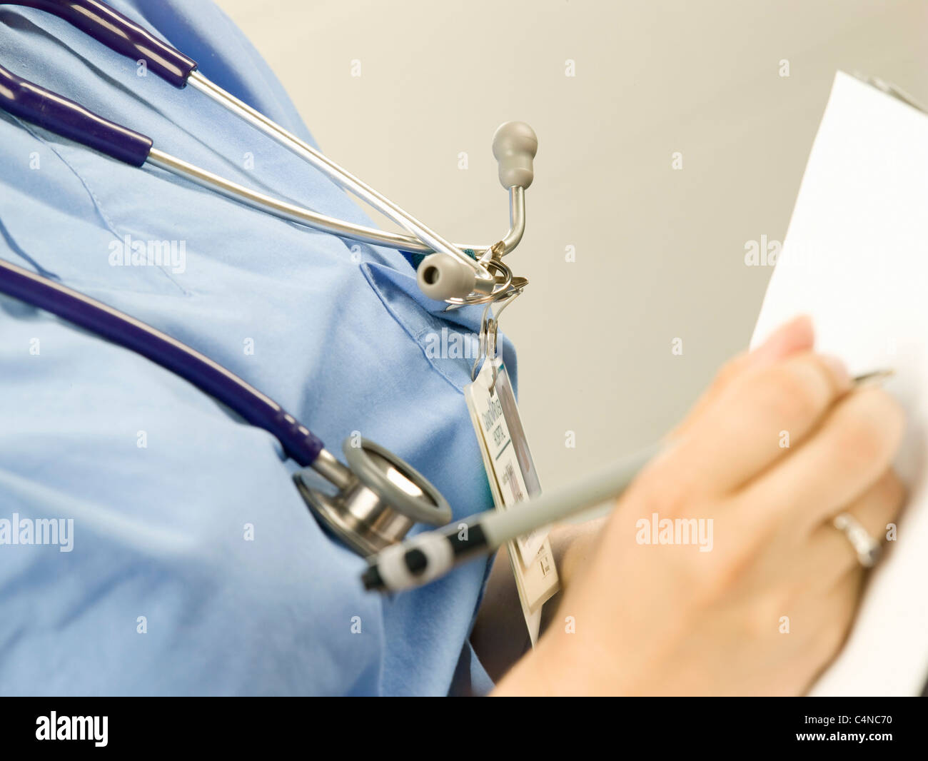 Close-up of nurse writing on chart Stock Photo - Alamy