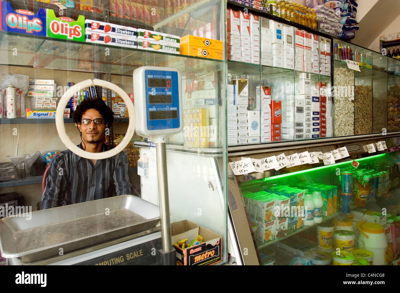 Man in his shop selling candies, chewing gums and cigarettes, Na'in ...