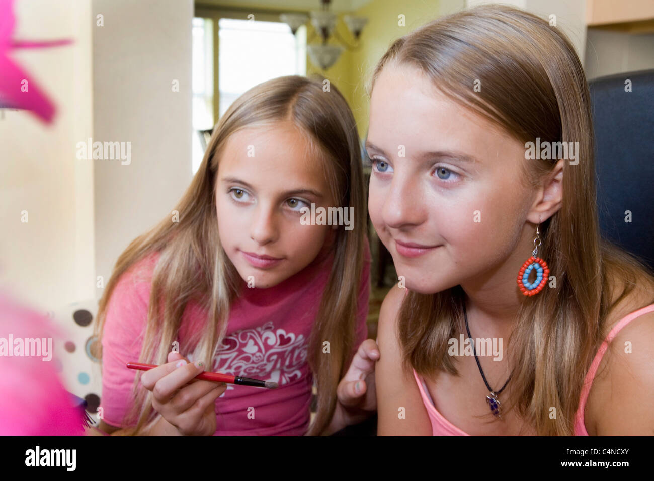 Two girls playing with make up at home Stock Photo - Alamy