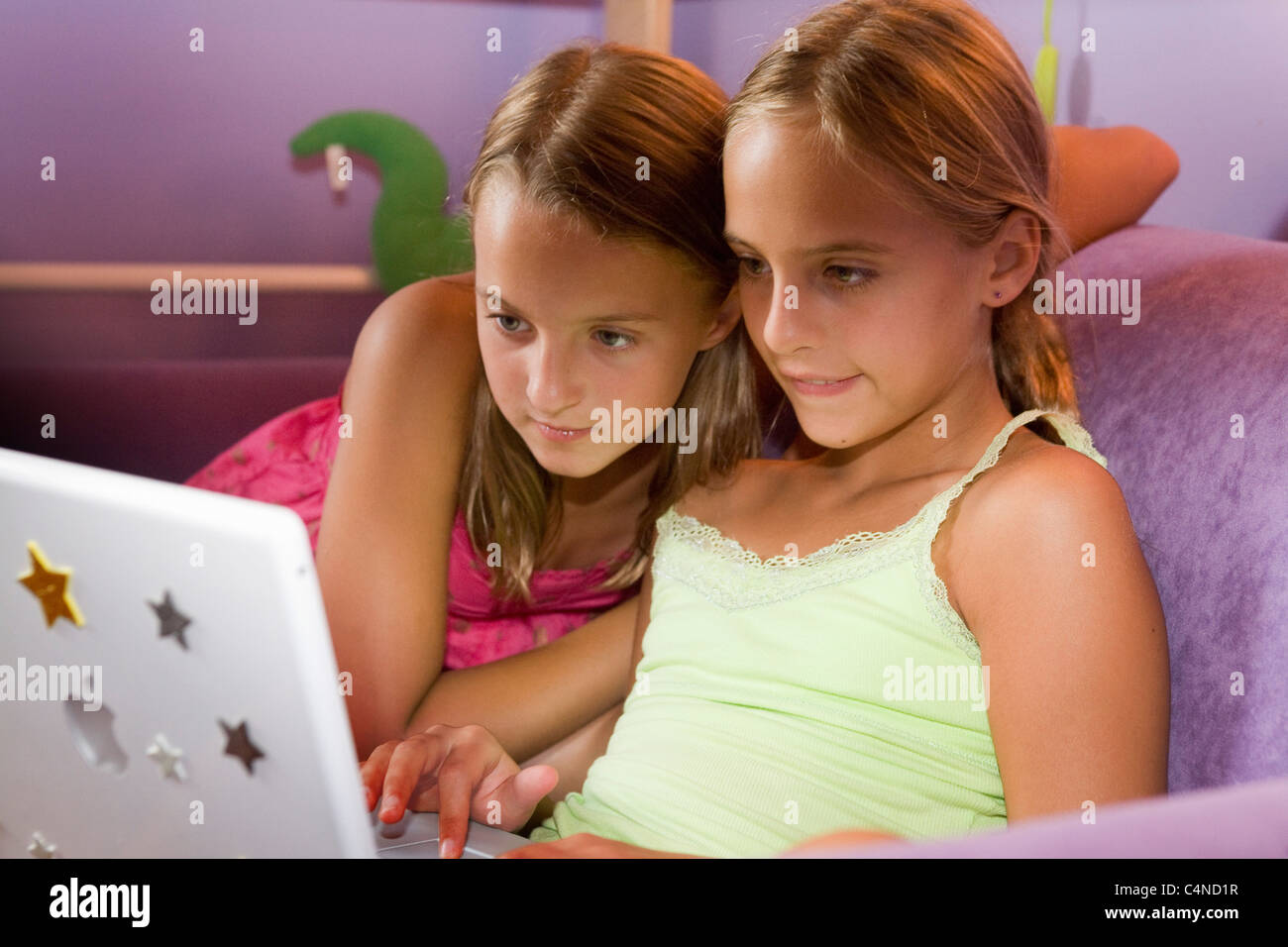 Two girls on laptop Stock Photo - Alamy
