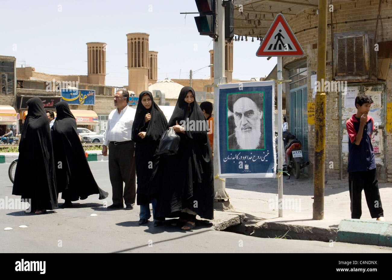 Iranian women in the street with ayatollah Khomeini poster, Yazd, Iran ...