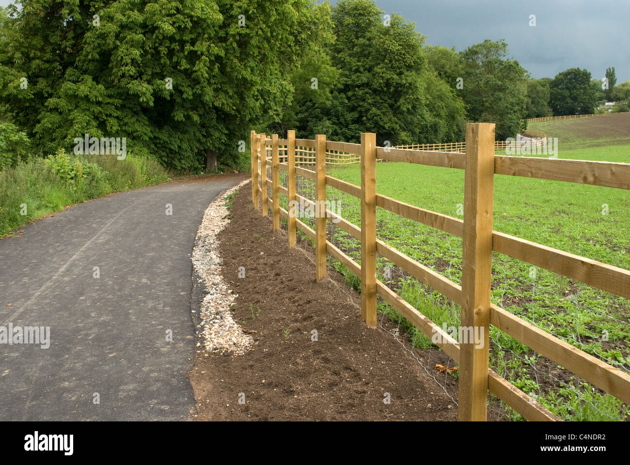 Country path edged by fence Stock Photo - Alamy