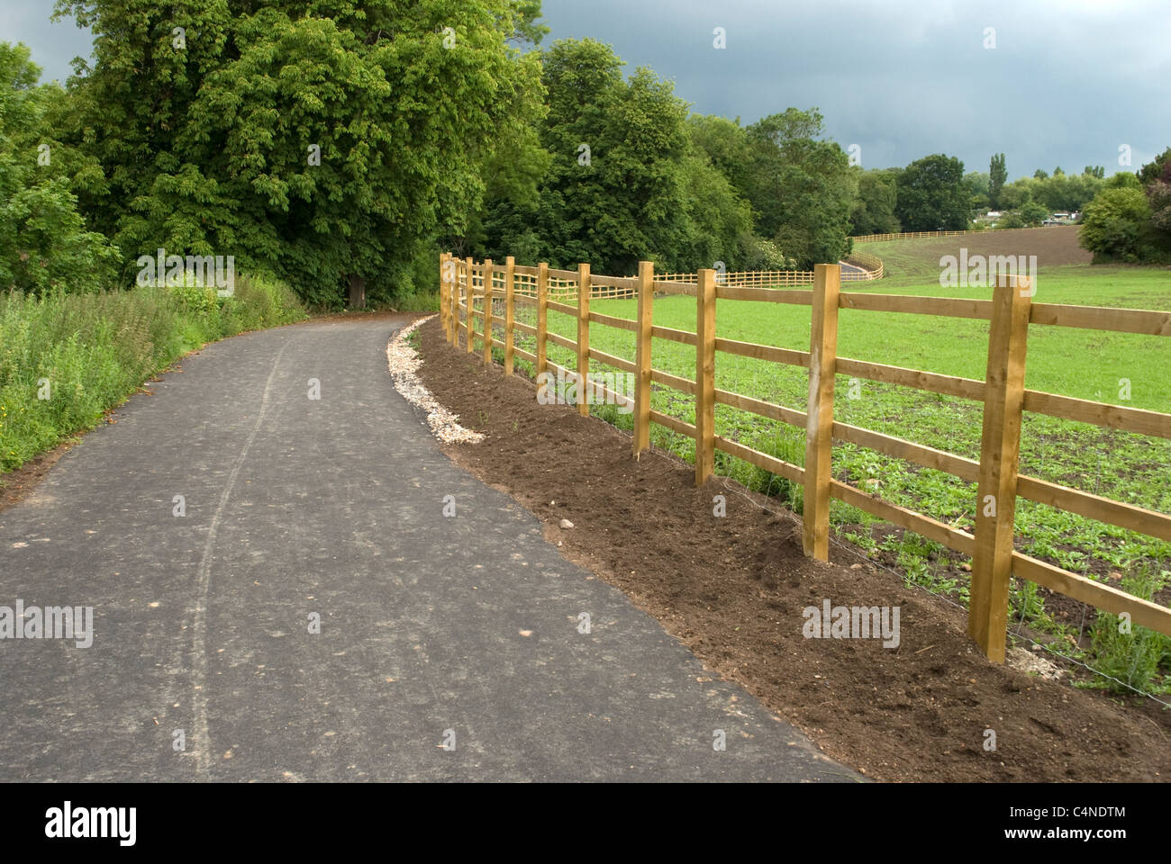 Country path edged by fence Stock Photo - Alamy