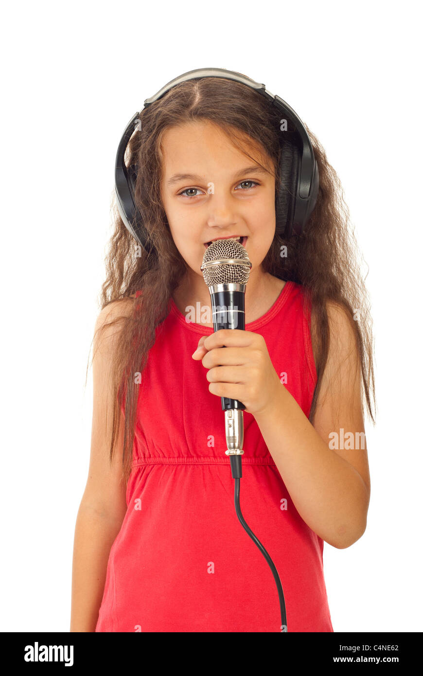 Beauty girl singing into microphone and listening in headphones ...