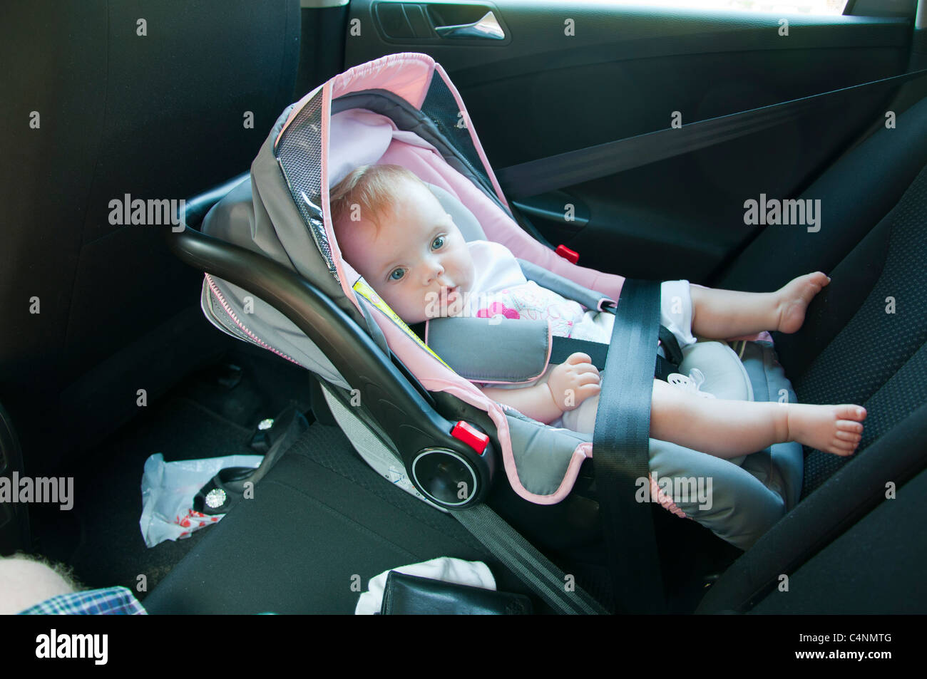beautiful, small girl with pacifier, sitting in a car seat Stock Photo ...