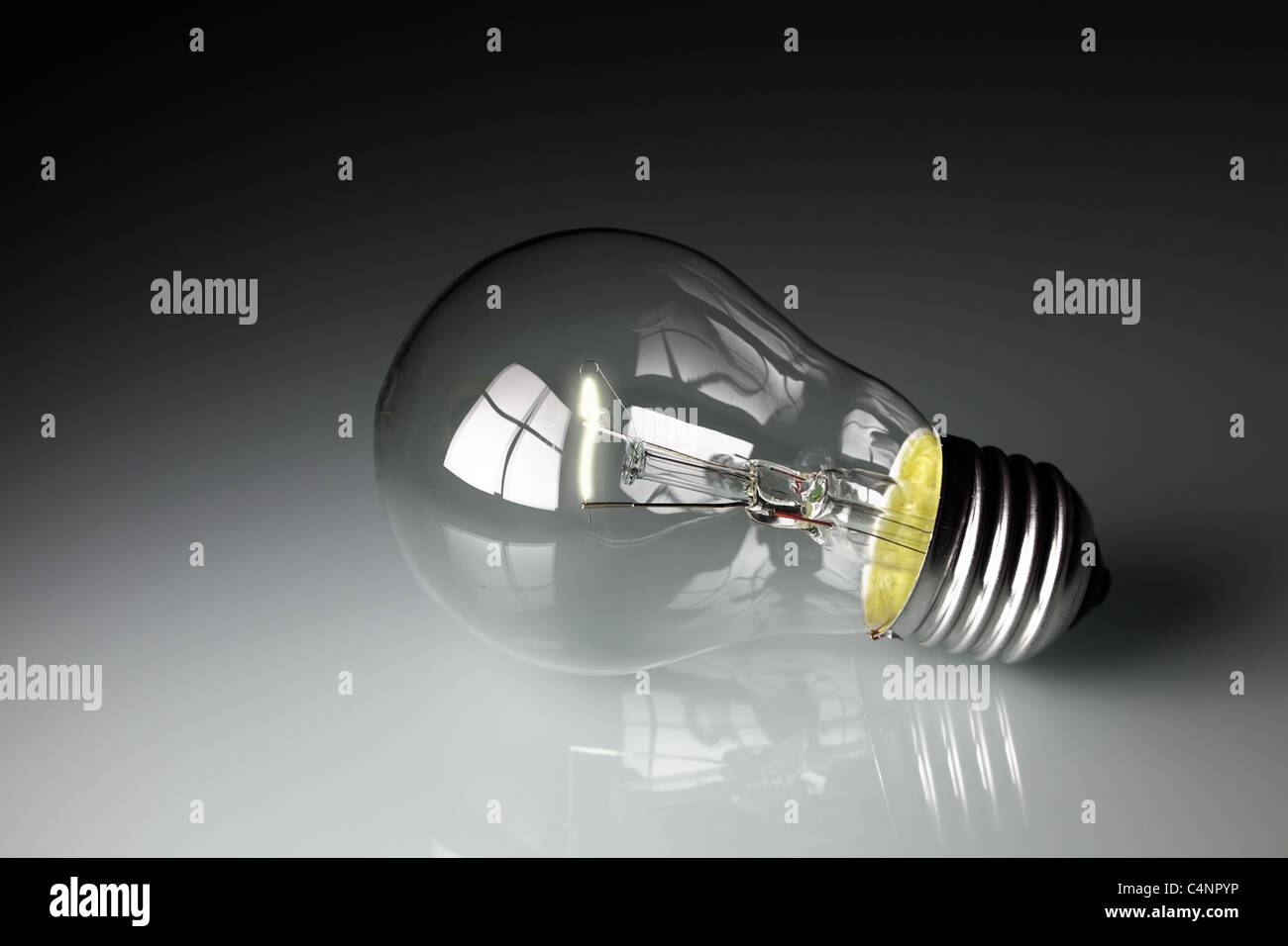 light bulb on a grey glass background with reflection Stock Photo - Alamy