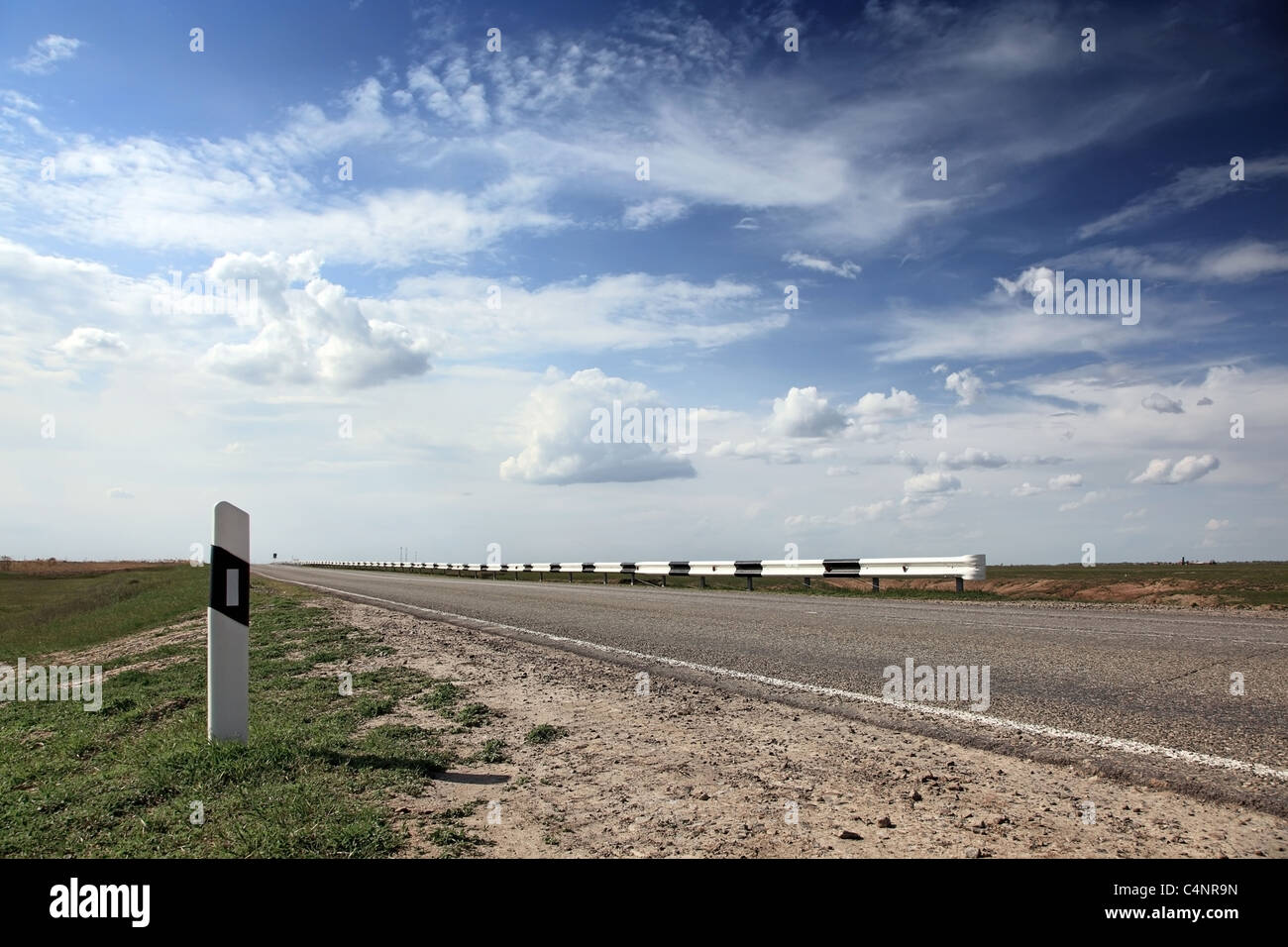 Countryside scene. Empty road and blue sky Stock Photo - Alamy