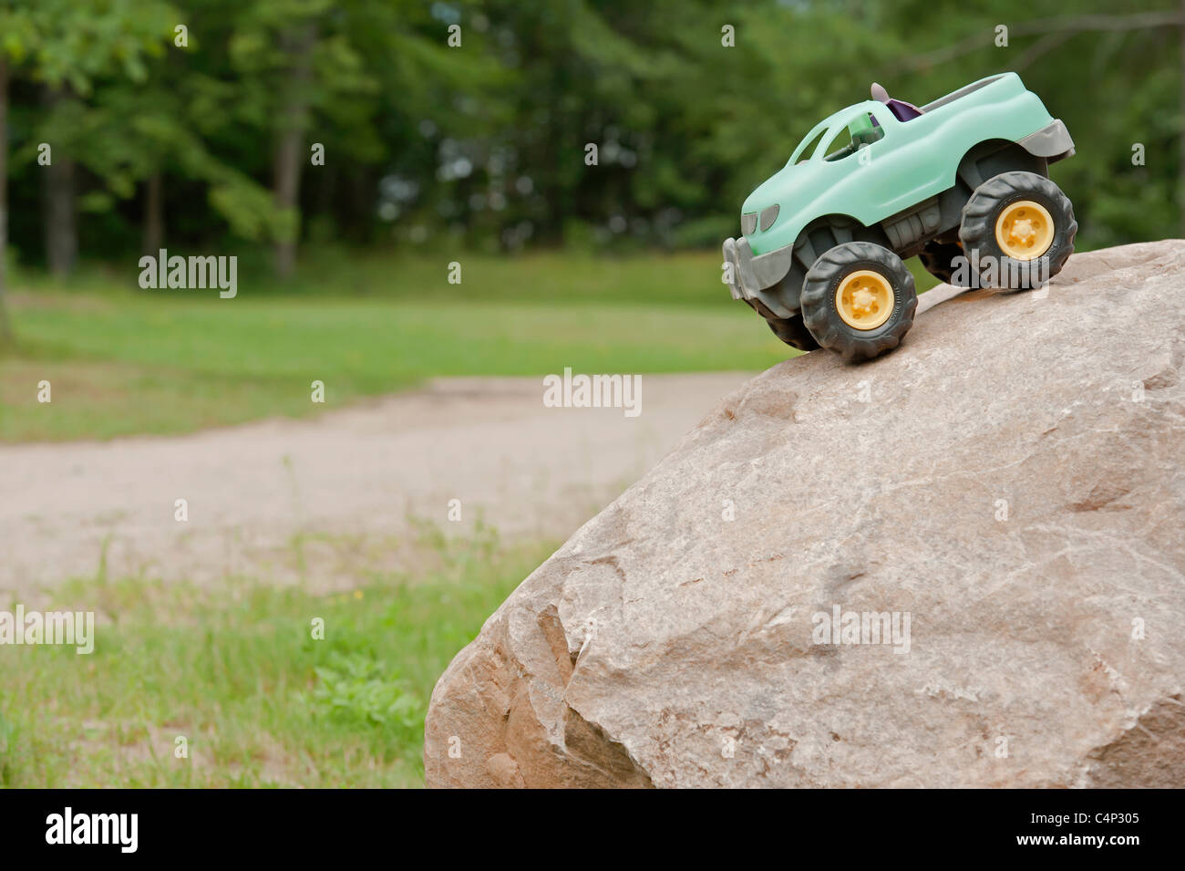 Little toy truck on a large rock Stock Photo - Alamy