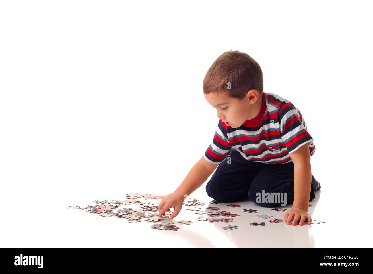 Young boy, age 4, building a puzzle Stock Photo - Alamy