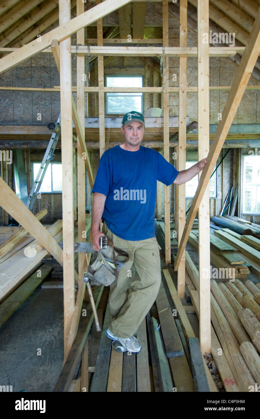 Carpenter standing in a cabin construction project Stock Photo - Alamy