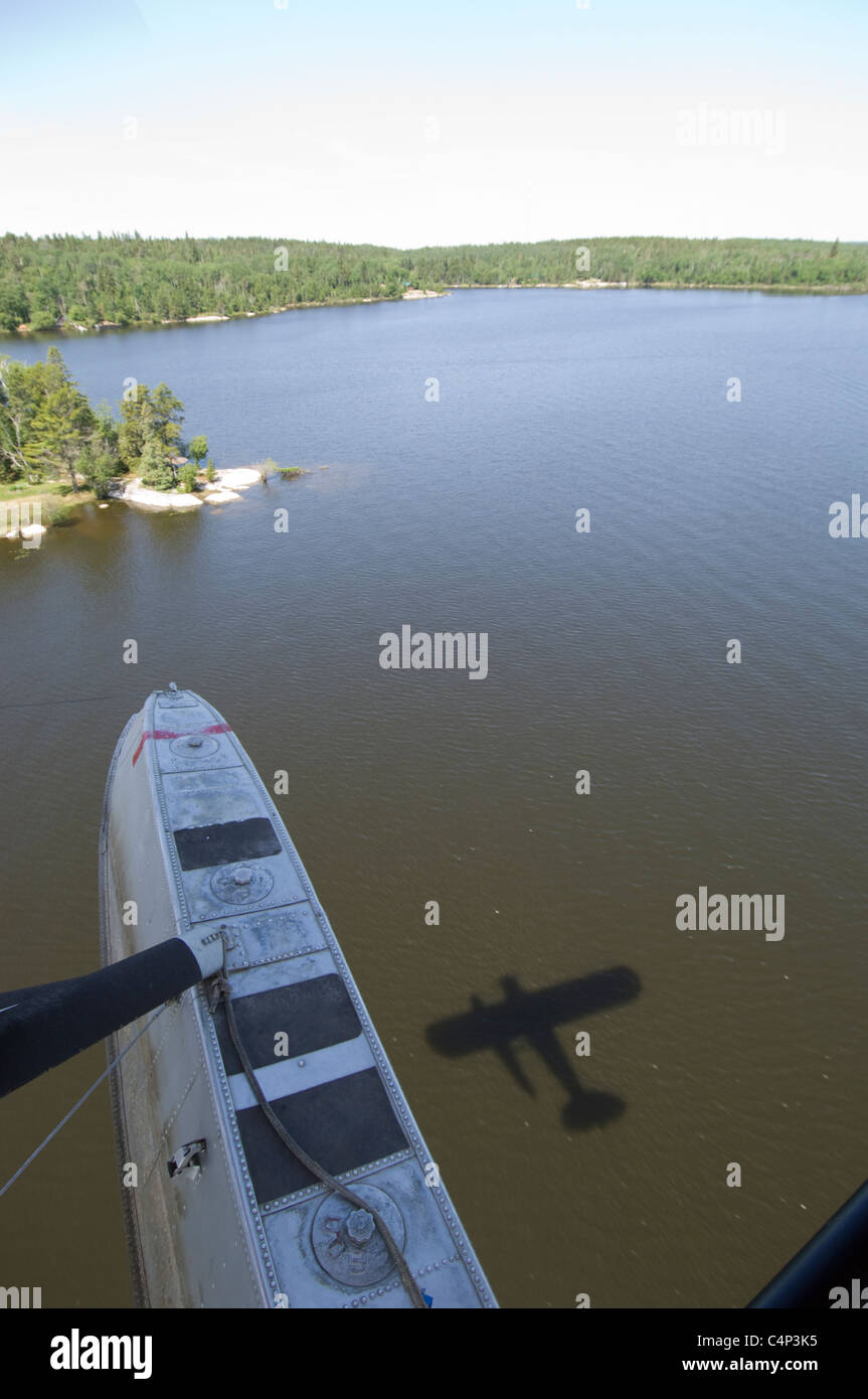 Aerial view from a Piper Cub float plane of its shadow on Gunn Lake ...