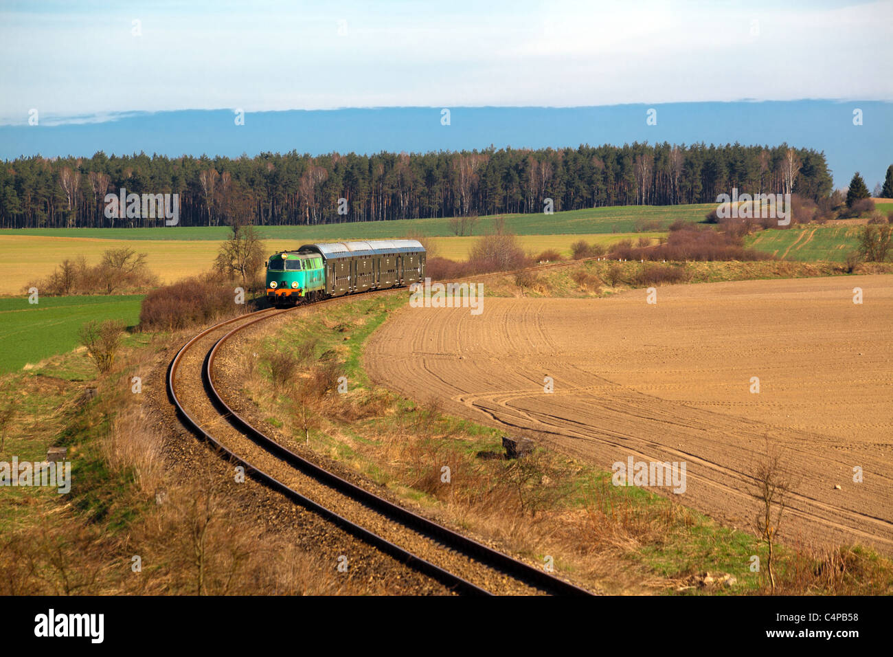 Passenger train passing through countryside Stock Photo - Alamy