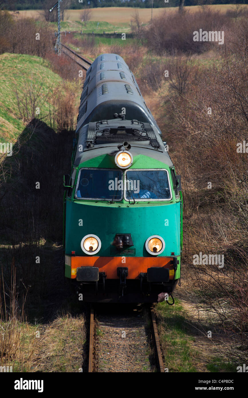 Passenger train passing through countryside Stock Photo - Alamy