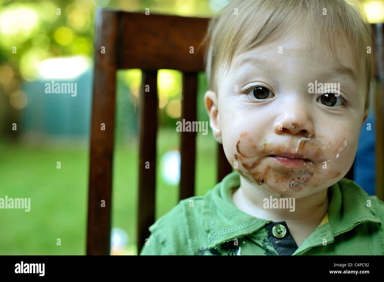 1-year-old boy on first birthday with cake icing on face Stock Photo ...