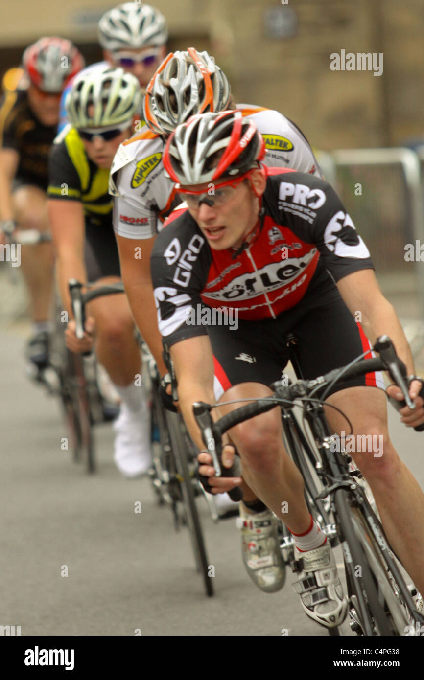 Professional cyclists competing in town centre road race Stock Photo ...