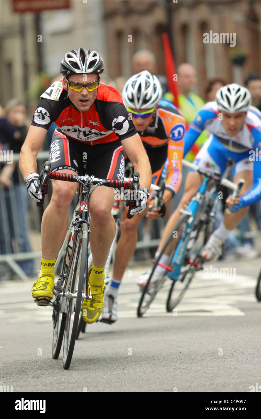 Professional cyclists competing in town centre road race Stock Photo ...