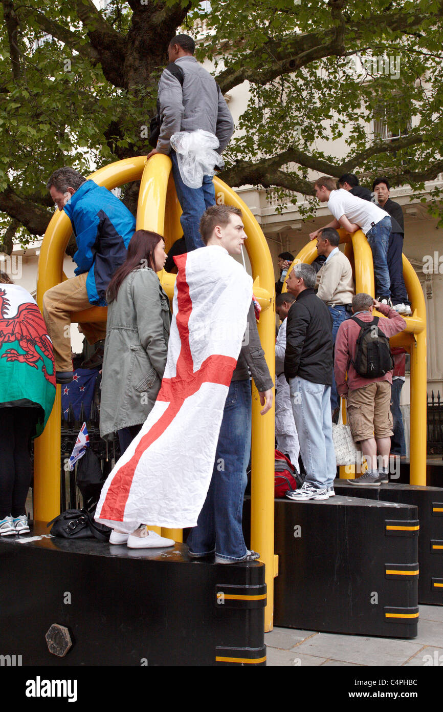 Royal Wedding 2011: Spectators climb on security gates to see over the ...