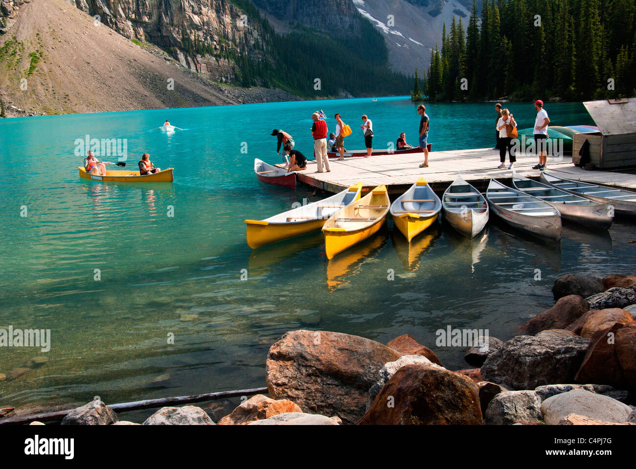 Tourists renting canoes on Moraine Lake in the Valley of the Ten Peaks, Alberta, Canada Stock ...