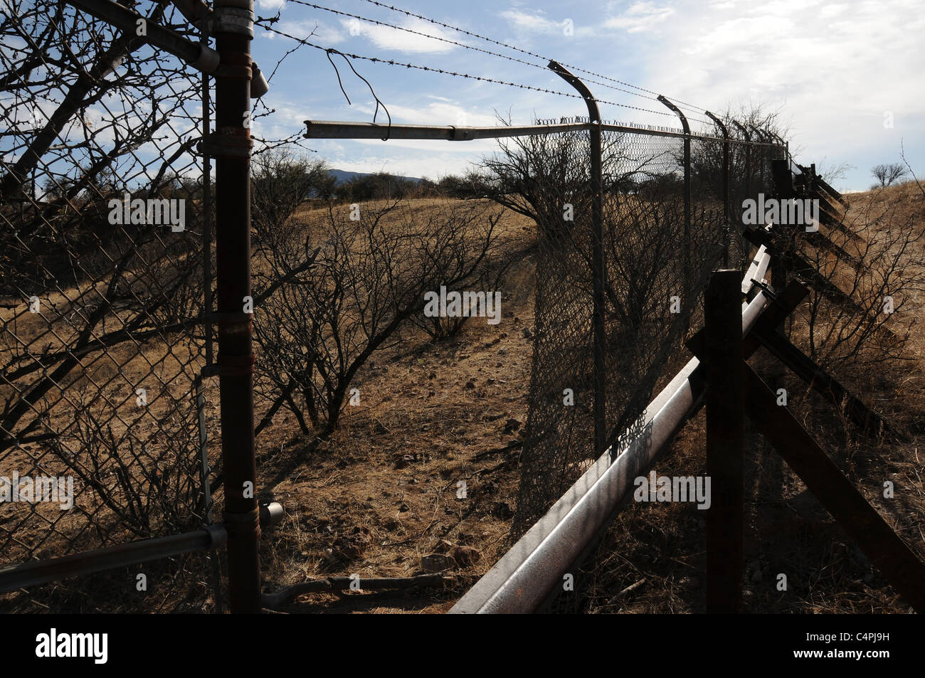 Holes cut in the fence at the Mexican border between Sonora and Lochiel ...