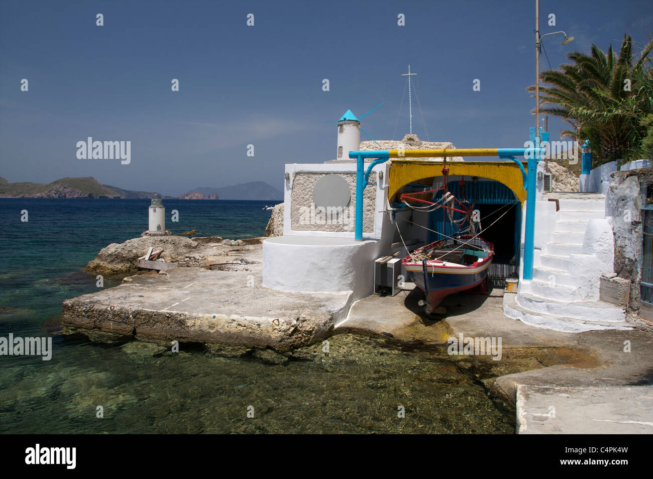 Caique fishing boat in traditional boat house, Milos in the Cyclades ...