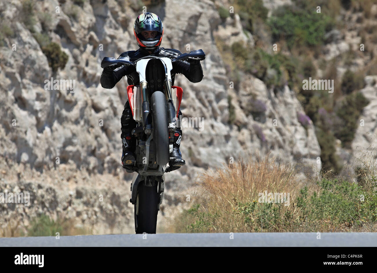 Man doing a wheelie with his race motorcycle in Kefalos Kos Greece ...