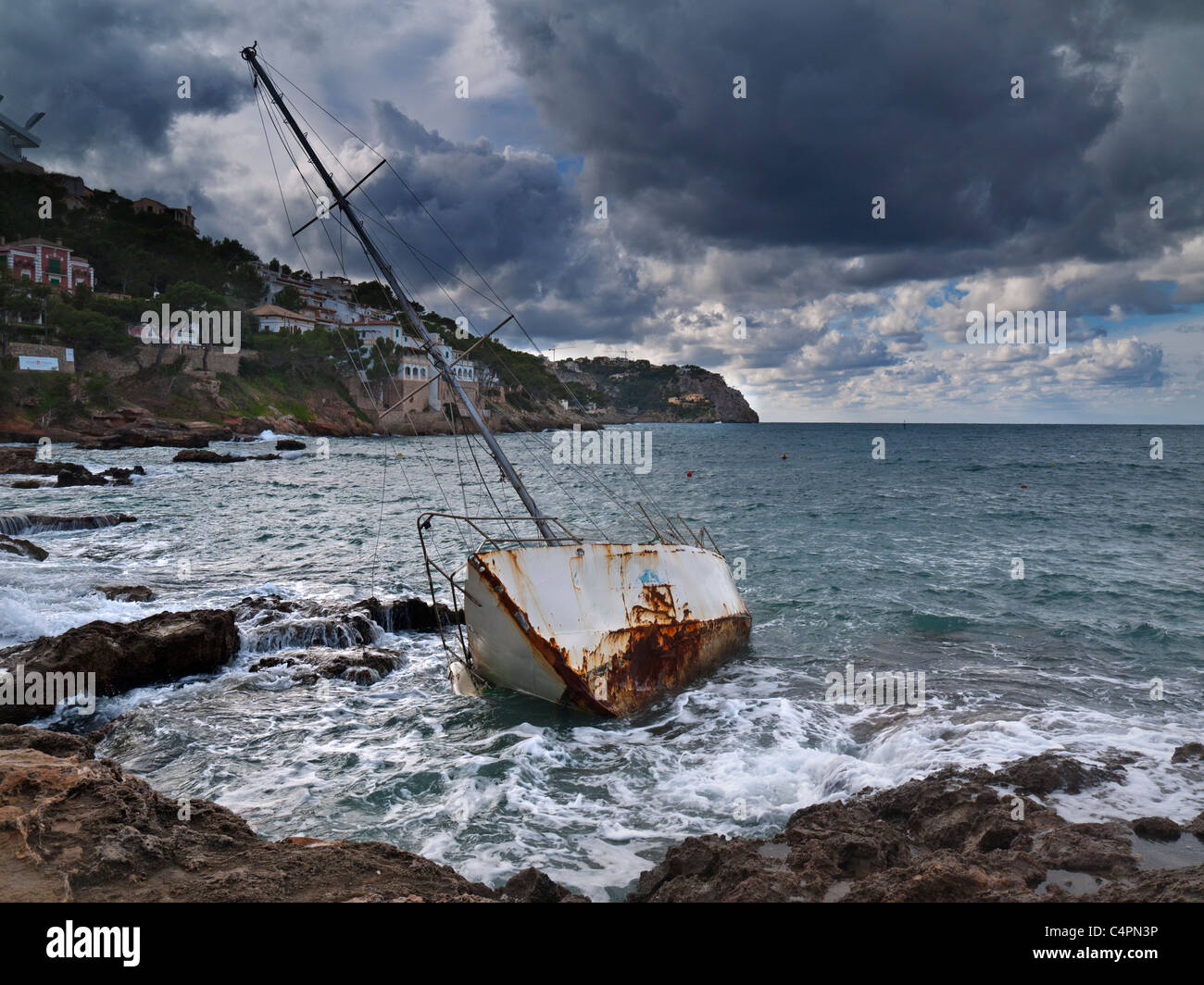 Ship wrecked sailing yacht stranded on the rocks at Andratx Harbour ...
