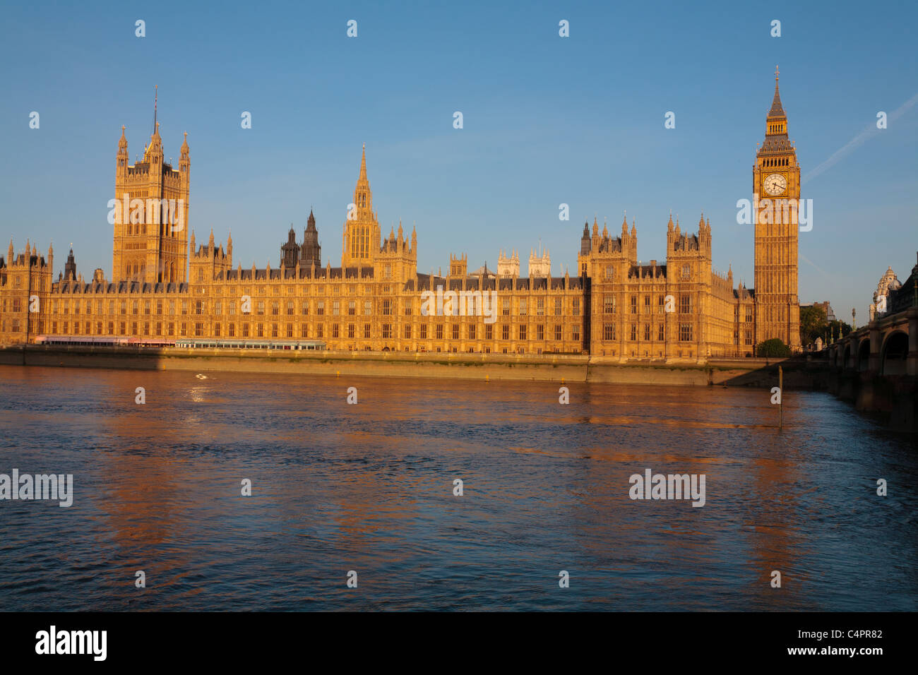 The Houses of Parliament in Westminster, London, England glow warmly in ...