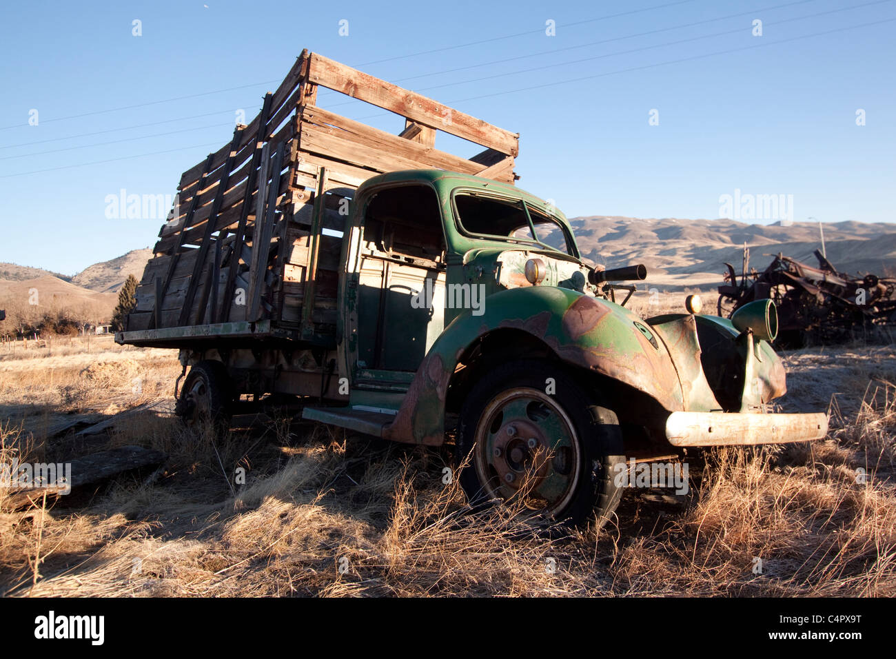 old rusty farm equipment in the middle of a field Stock Photo - Alamy