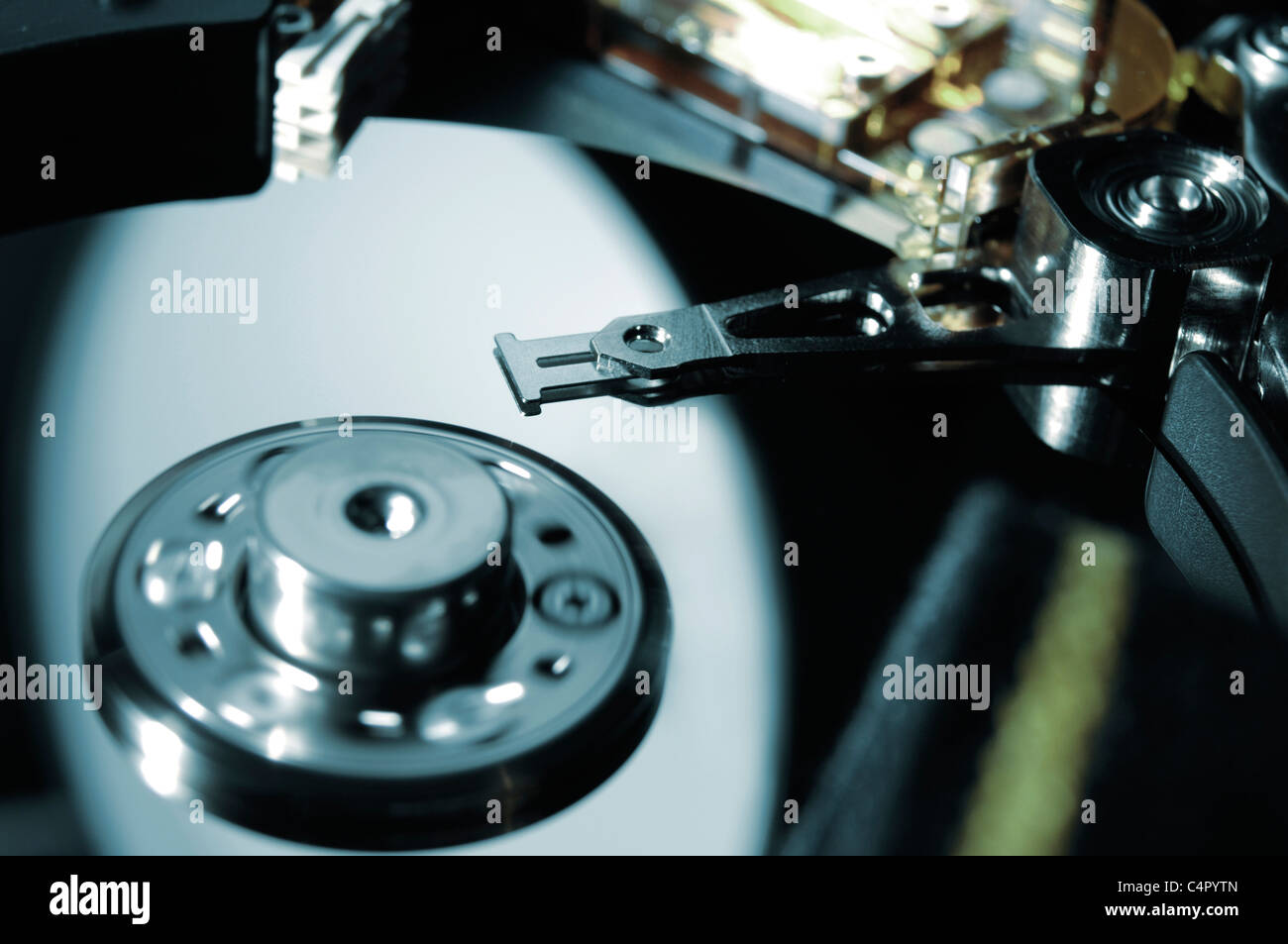 Close-up of a working hard disk drive with heads in reading position ...