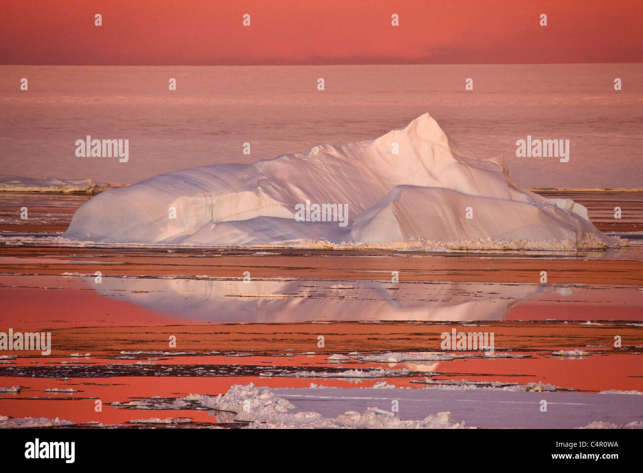 Huge iceberg and ice floes in the ocean at sunrise, Antarctica Stock ...