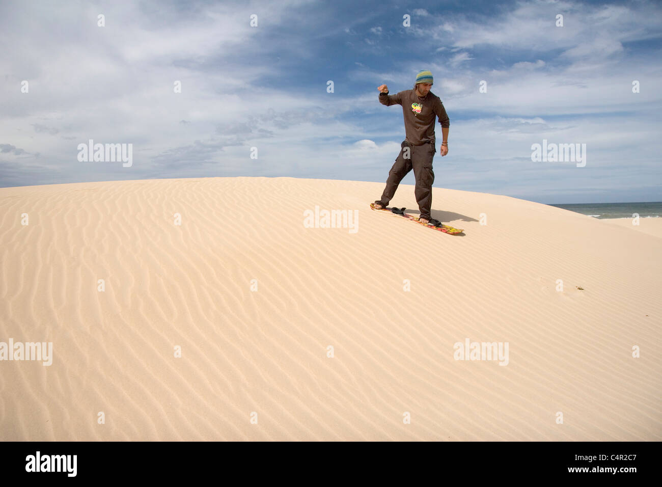 Man sandboarding, Jeffreys Bay, South Africa Stock Photo - Alamy