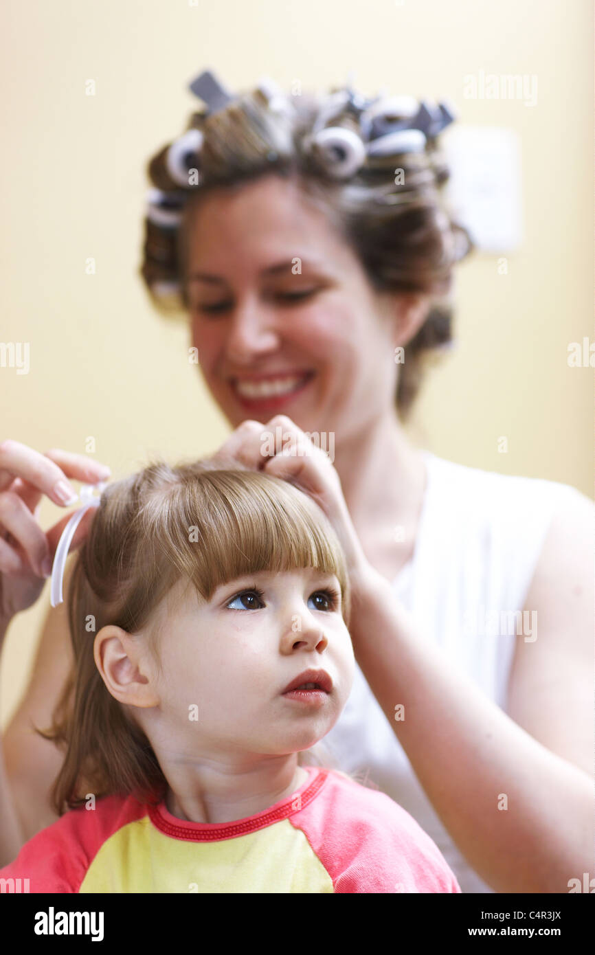 Mother fixing daughter's hair, Lachine, Quebec, Canada Stock Photo - Alamy