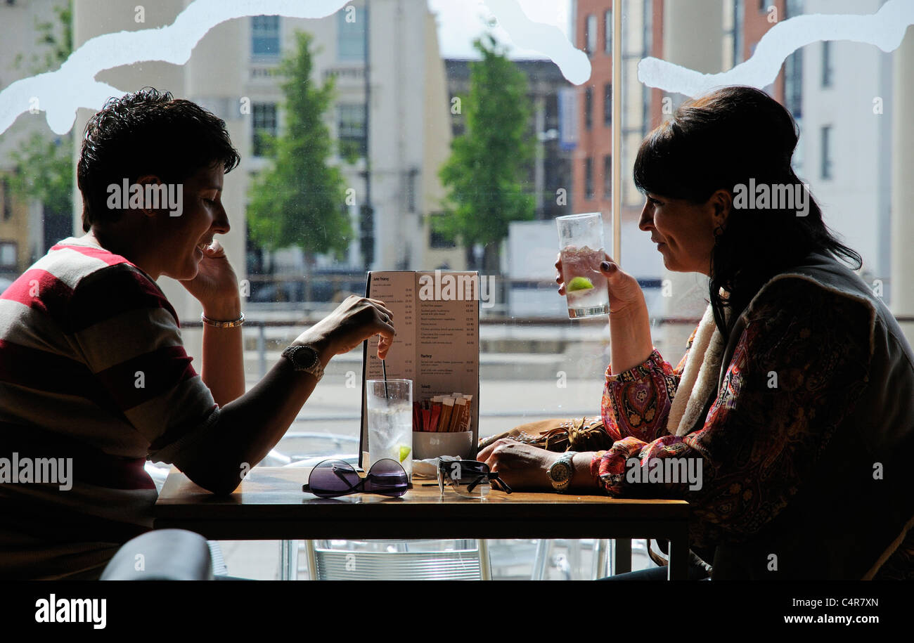 Two women drinking in a cafe bar Stock Photo - Alamy