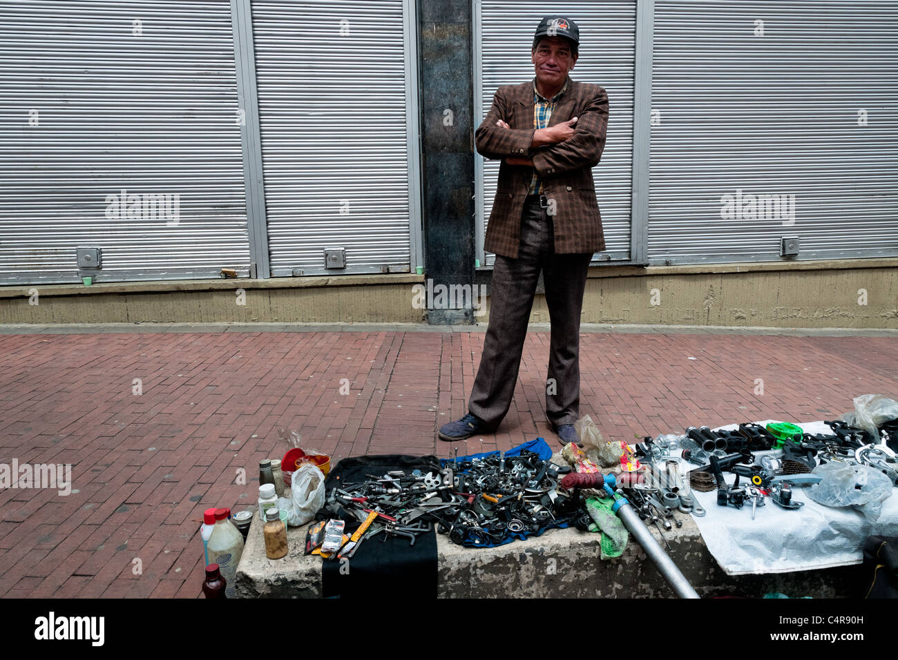 A Colombian service man stands in an improvised bicycle repair shop on ...
