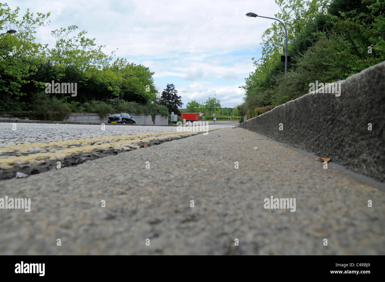 Low Level Angle Looking Down Pavement or Sidewalk Curb at Edge of Road ...
