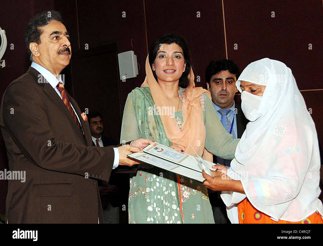 Prime Minister, Syed Yousuf Raza Gilani hands over the assistance ...