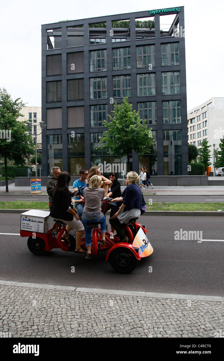 People riding a motorized multi seat conference bike in Berlin Germany ...