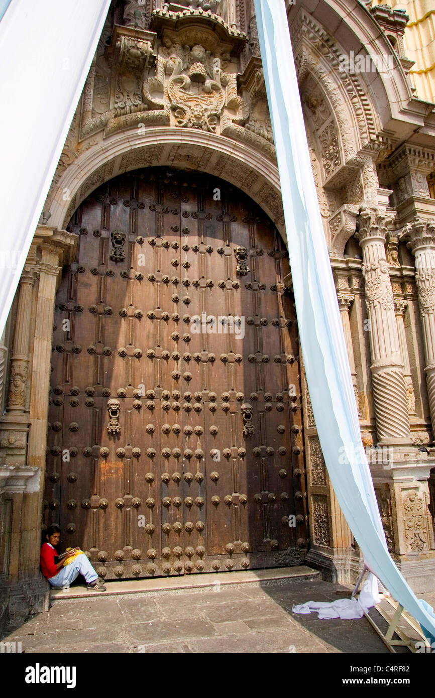 A woman seeking shade outside the Monastery of San Francisco, Lima ...
